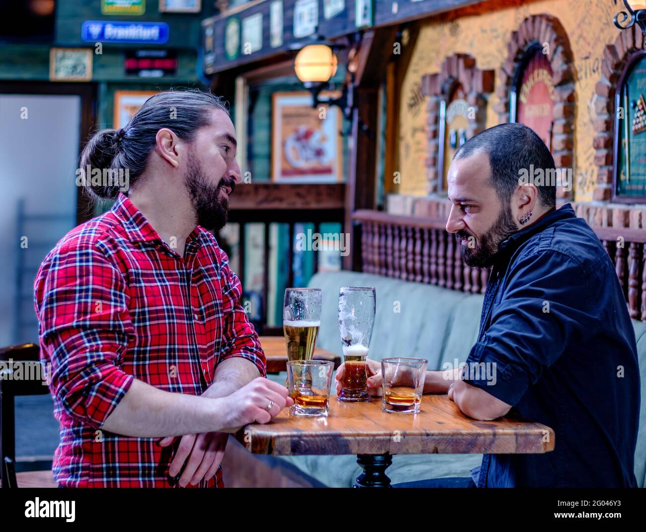 Two male friends drinking whiskey and beer together at the pub. They ...