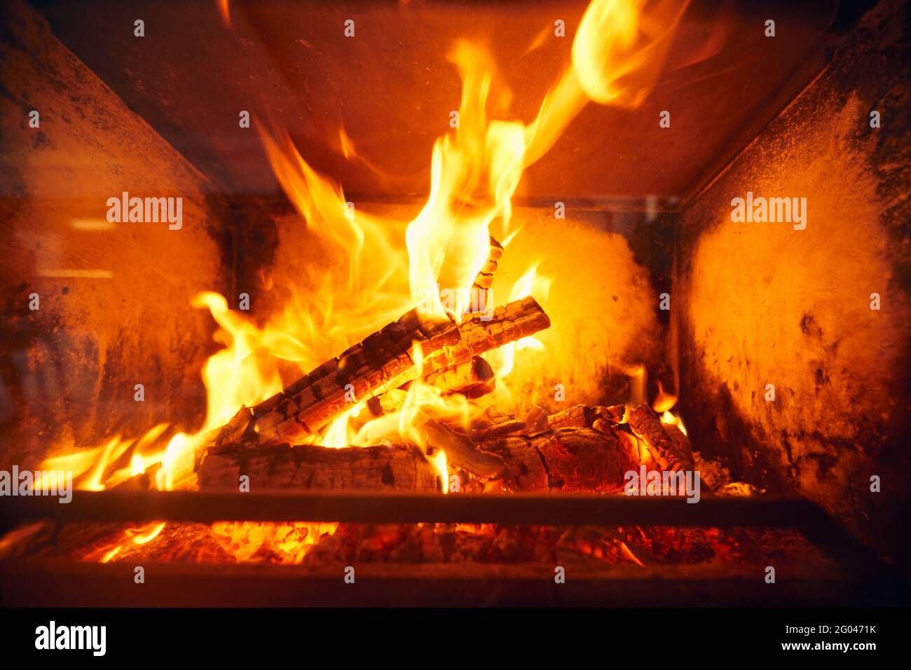 A fire burns in a fireplace, Fire to keep warm Stock Photo - Alamy