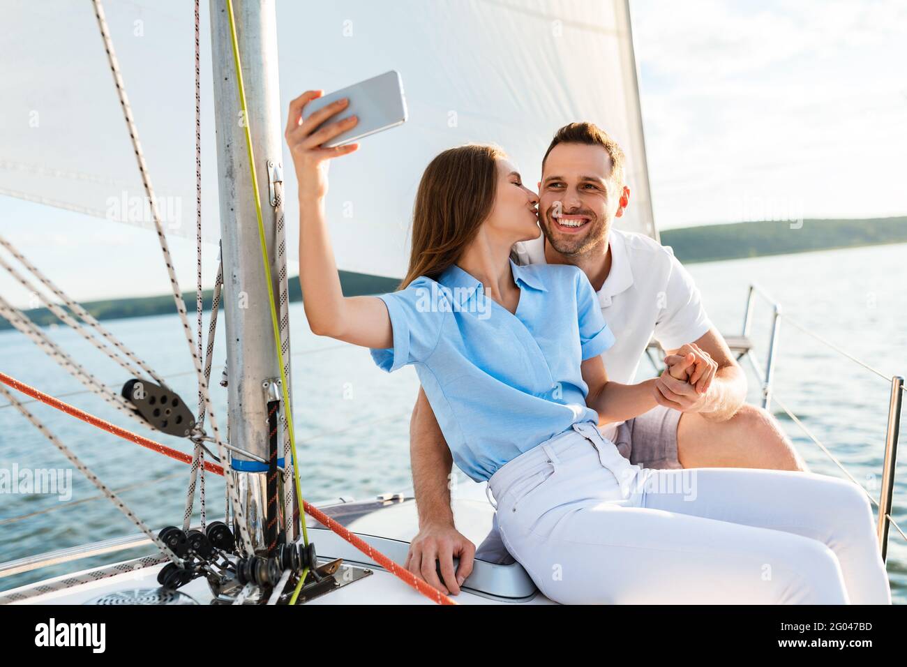 Loving Couple Making Selfie On Phone Kissing Enjoying Yacht Ride Stock