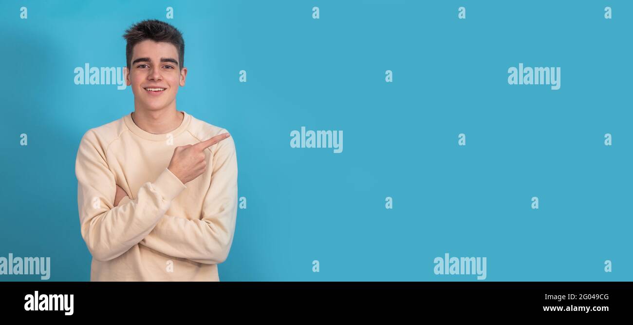 smiling teen boy pointing isolated Stock Photo - Alamy