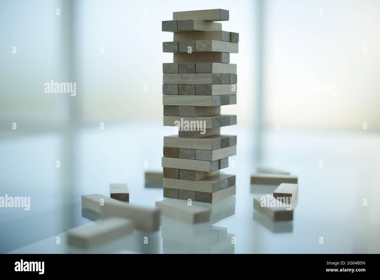 Wood Jenga on glass table Stock Photo - Alamy