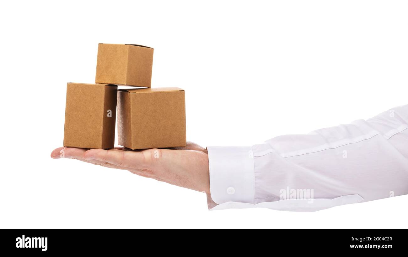Three cardboard boxes of different sizes on the palm of a man isolated ...