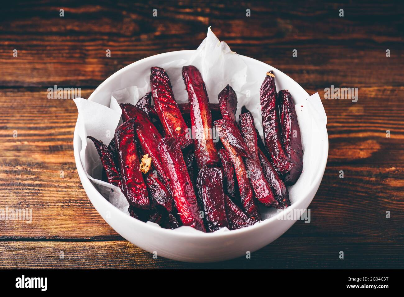 Oven baked beet fries in white bowl Stock Photo - Alamy