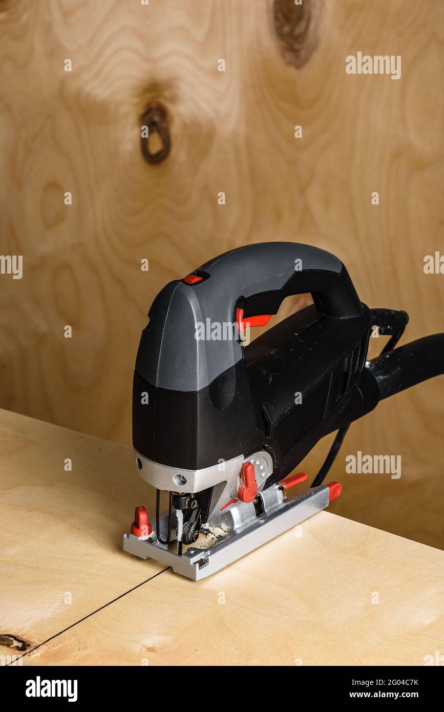 Electric jig saw cutting plywood Stock Photo - Alamy