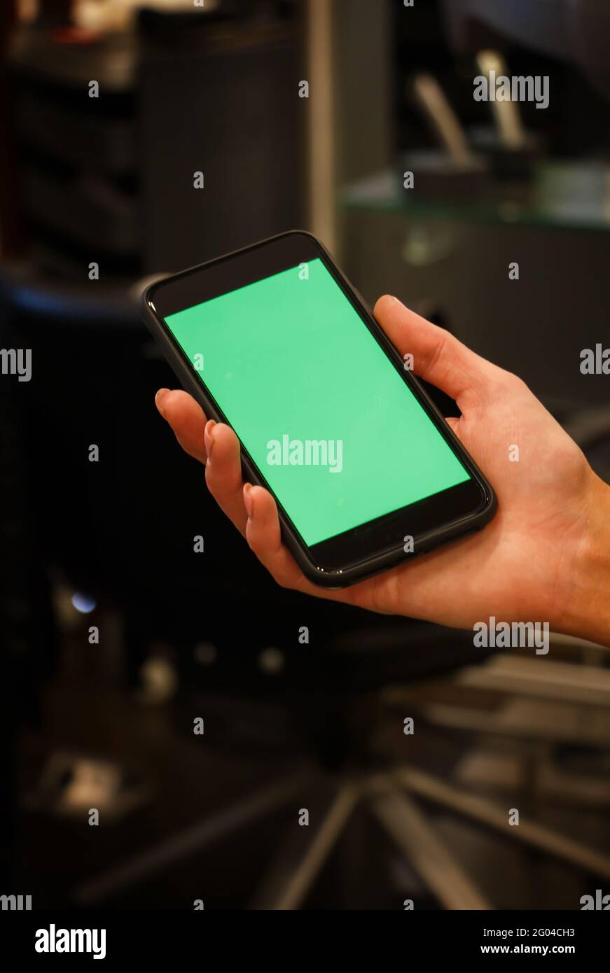 The human hand shows a mobile smartphone with a green screen Stock ...