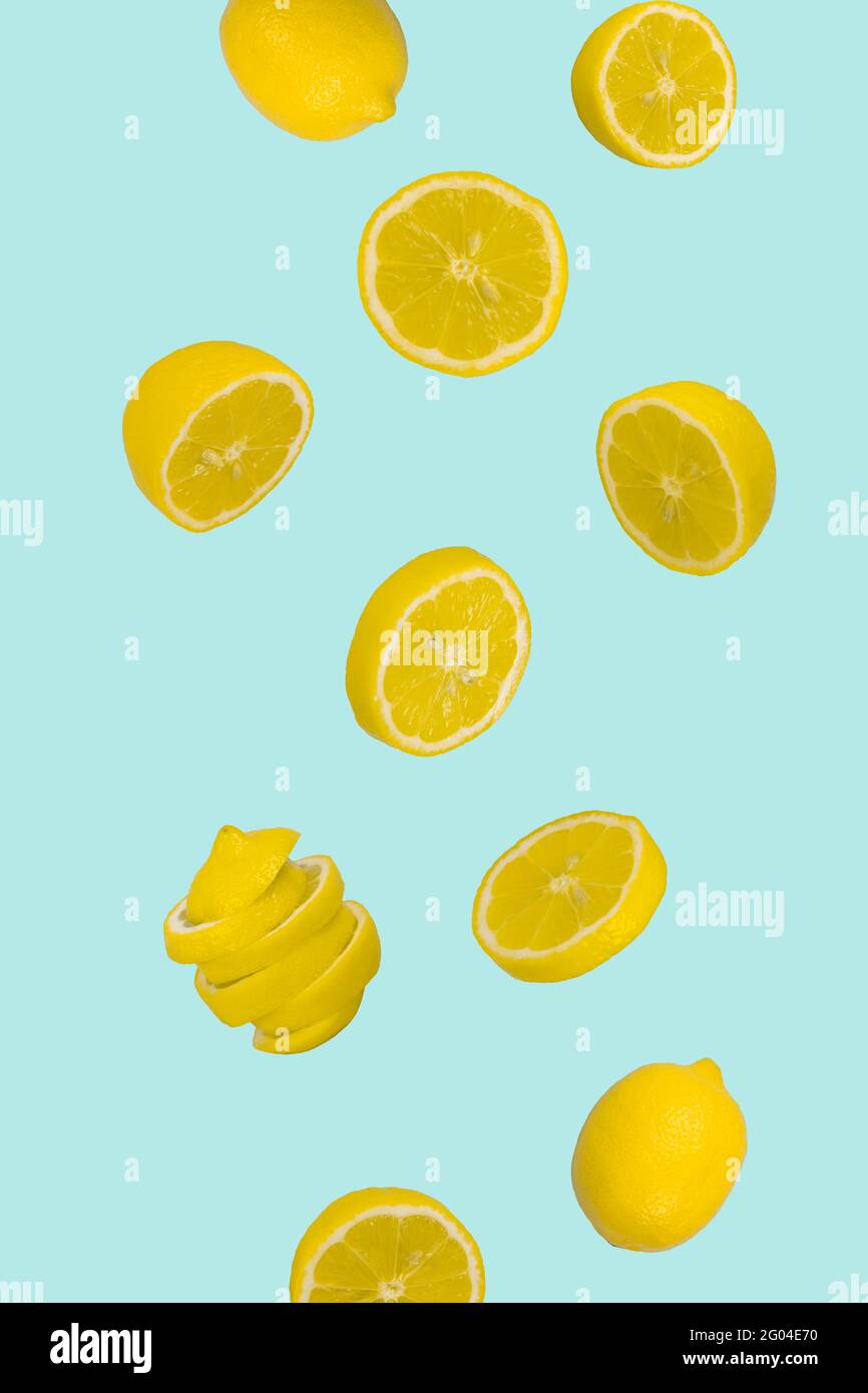 Floating levitating fresh and sliced lemon on pastel blue background ...