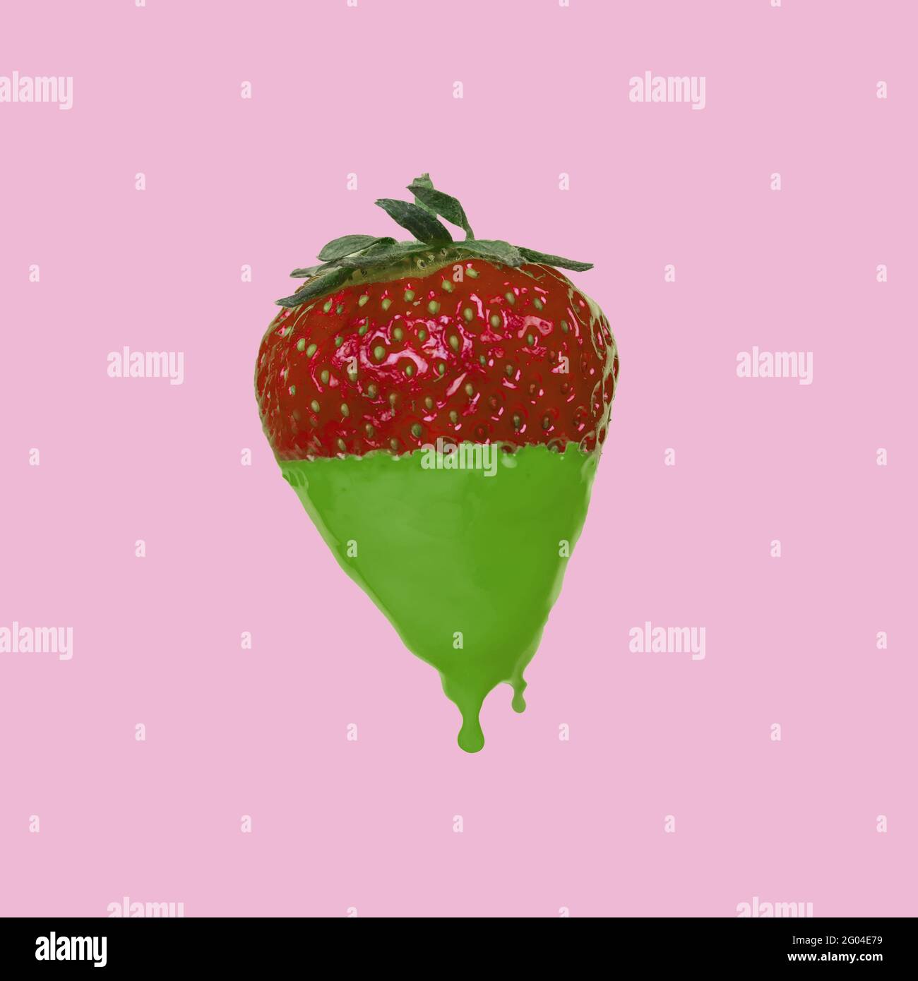 Minimal concept made with strawberry dripping with green paint on pink ...