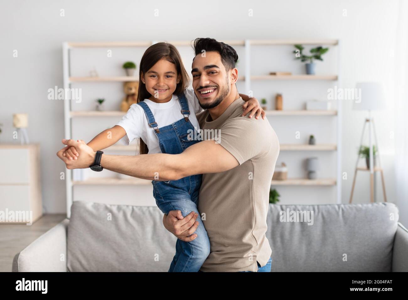 Dad and daughter dancing in living room together Stock Photo - Alamy