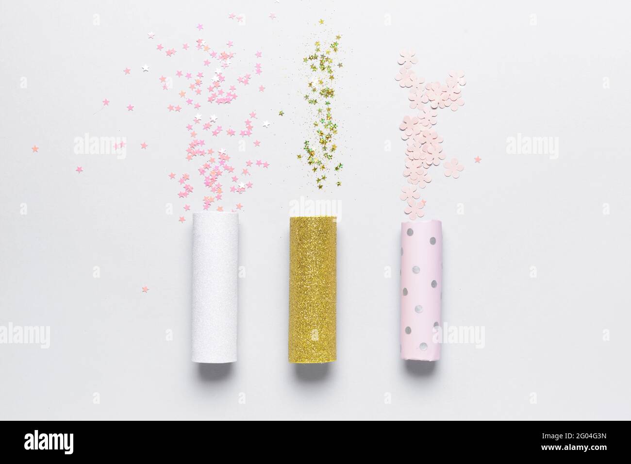 Party poppers and confetti on white background Stock Photo - Alamy