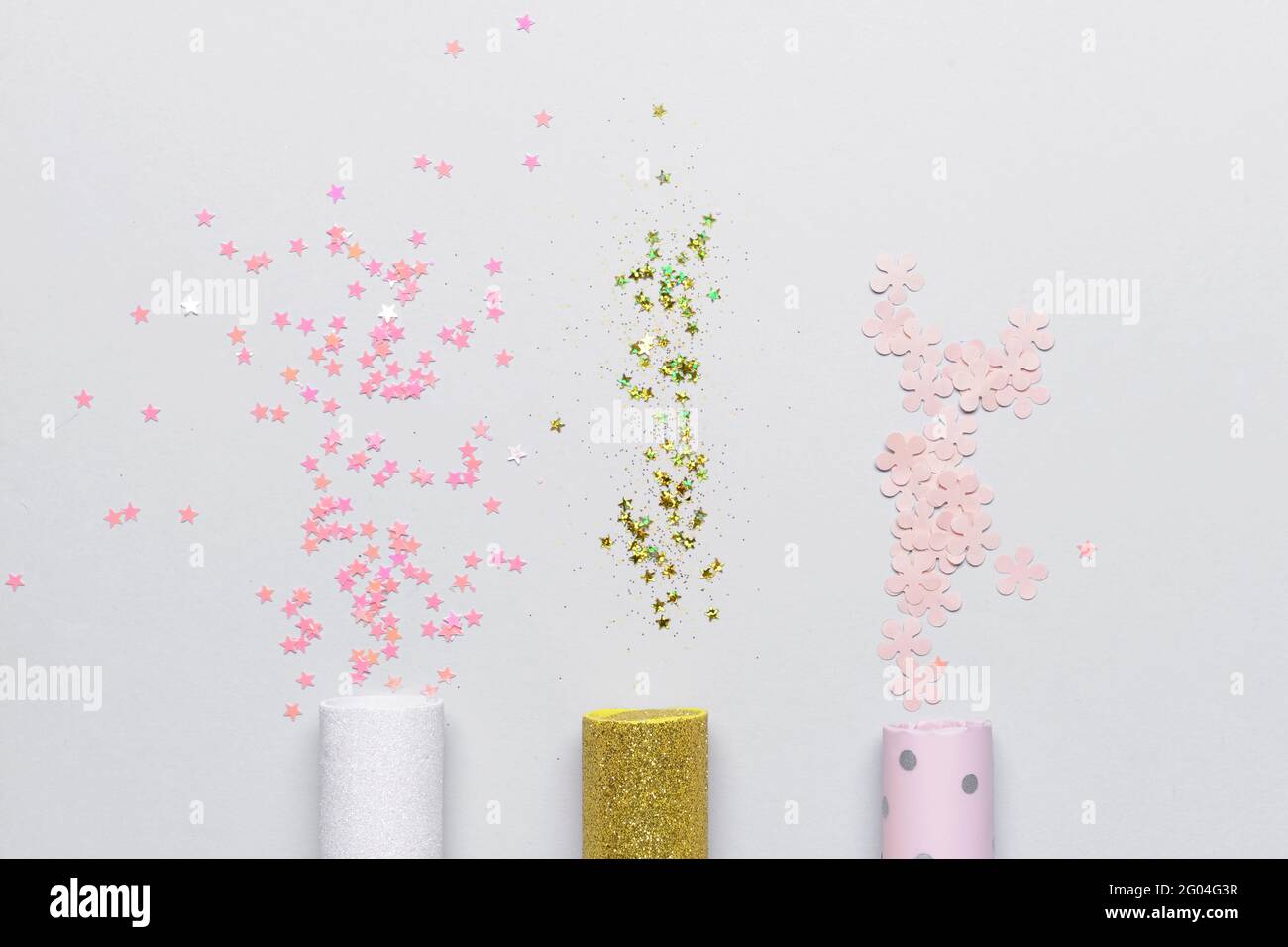 Party poppers and confetti on white background Stock Photo - Alamy