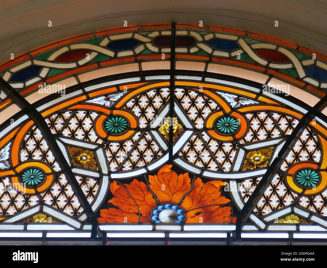 Close-up of the coloured, floral patterned stained glass windows in the ...