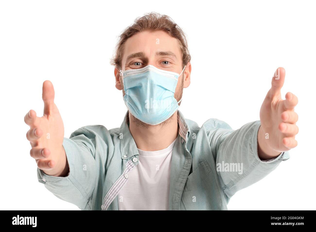 Young man in medical mask opening arms for hug on white background ...