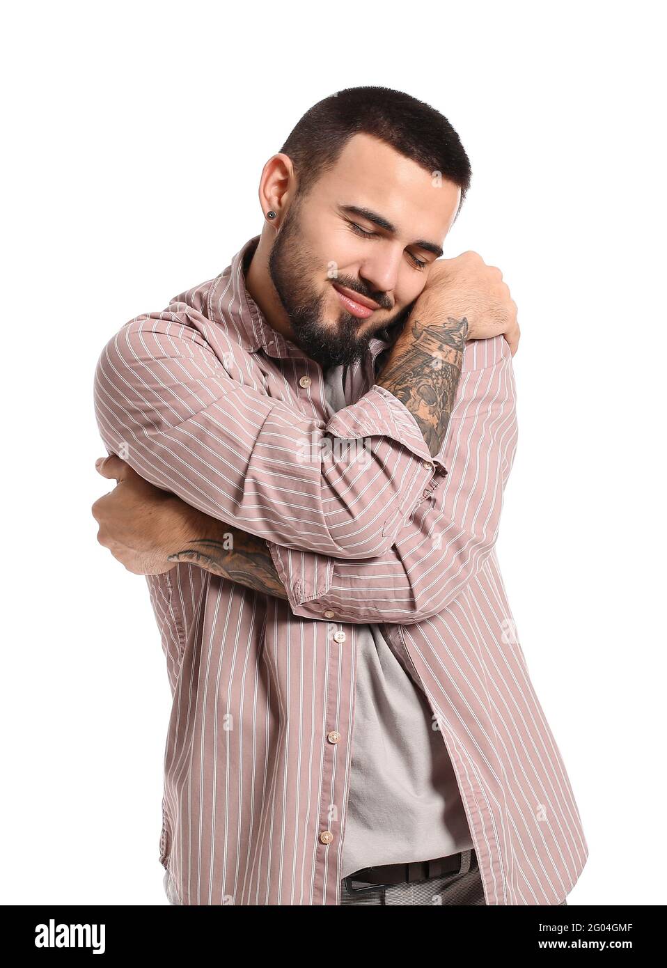 Young man hugging himself on white background Stock Photo - Alamy