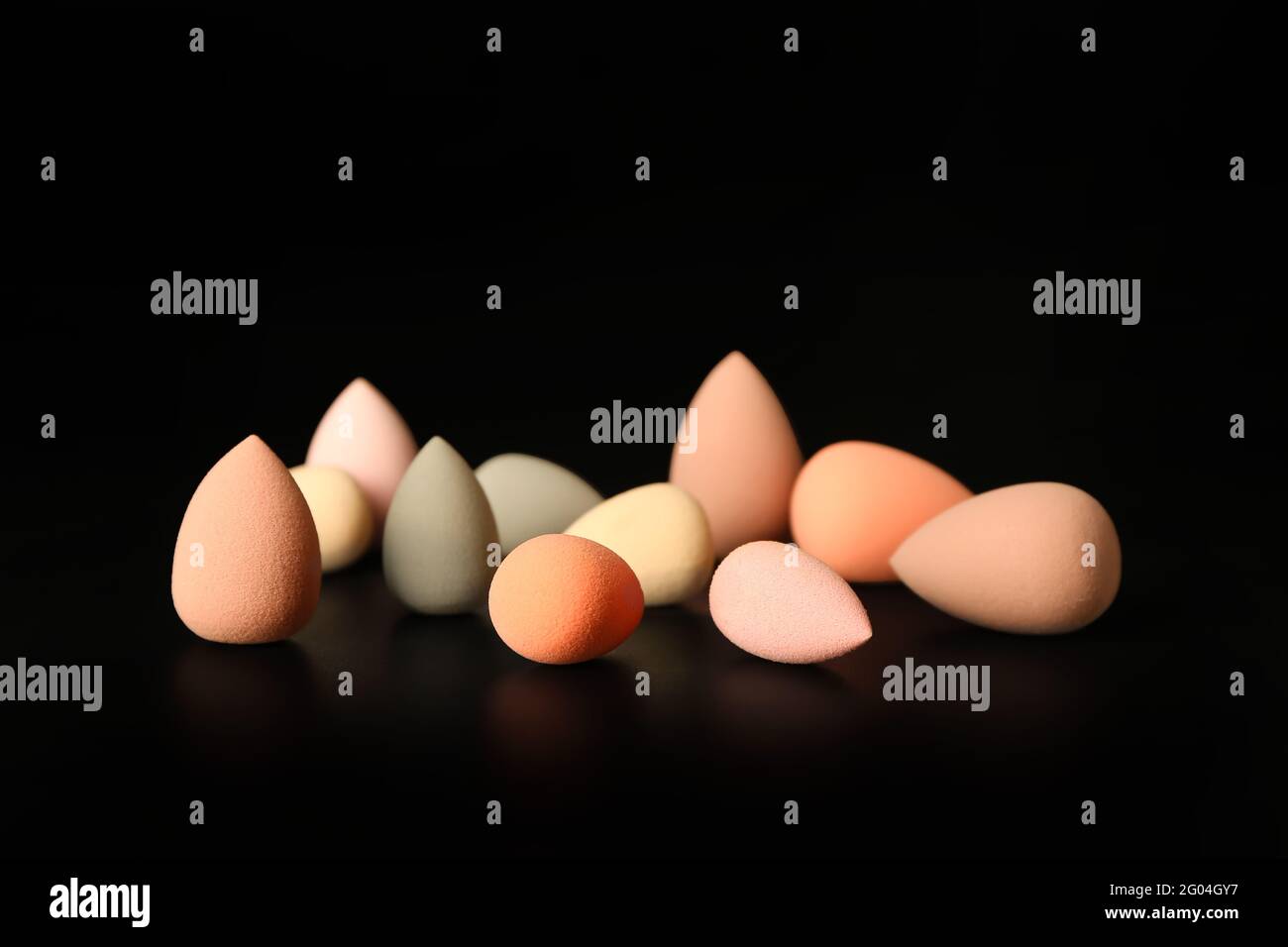 Different makeup sponges on dark background Stock Photo - Alamy