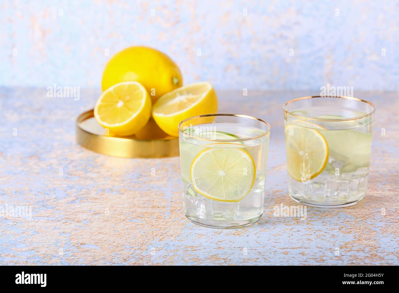 Glasses of tasty cold lemonade on light background Stock Photo - Alamy