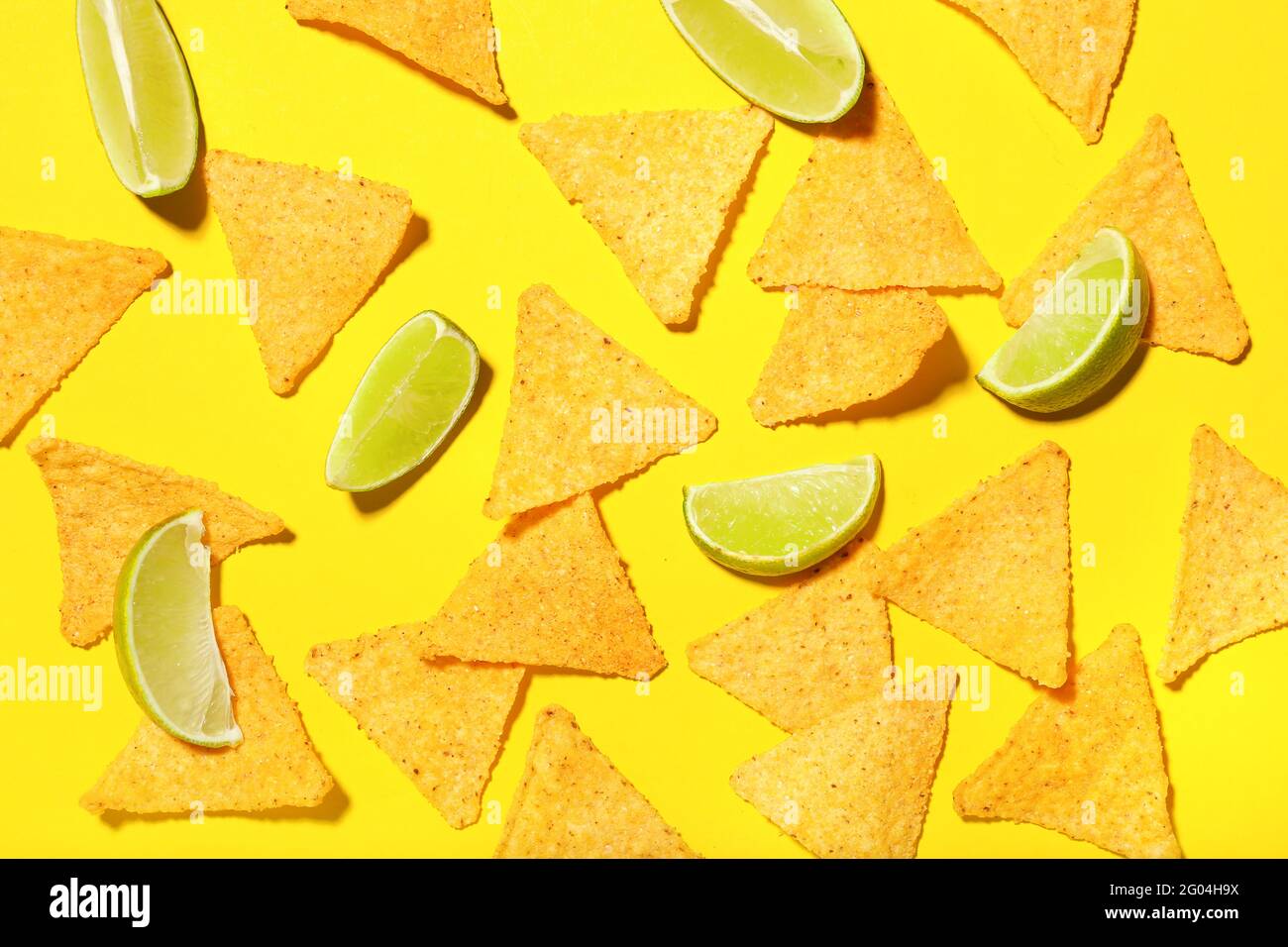 Tasty nachos with lime on color background Stock Photo - Alamy