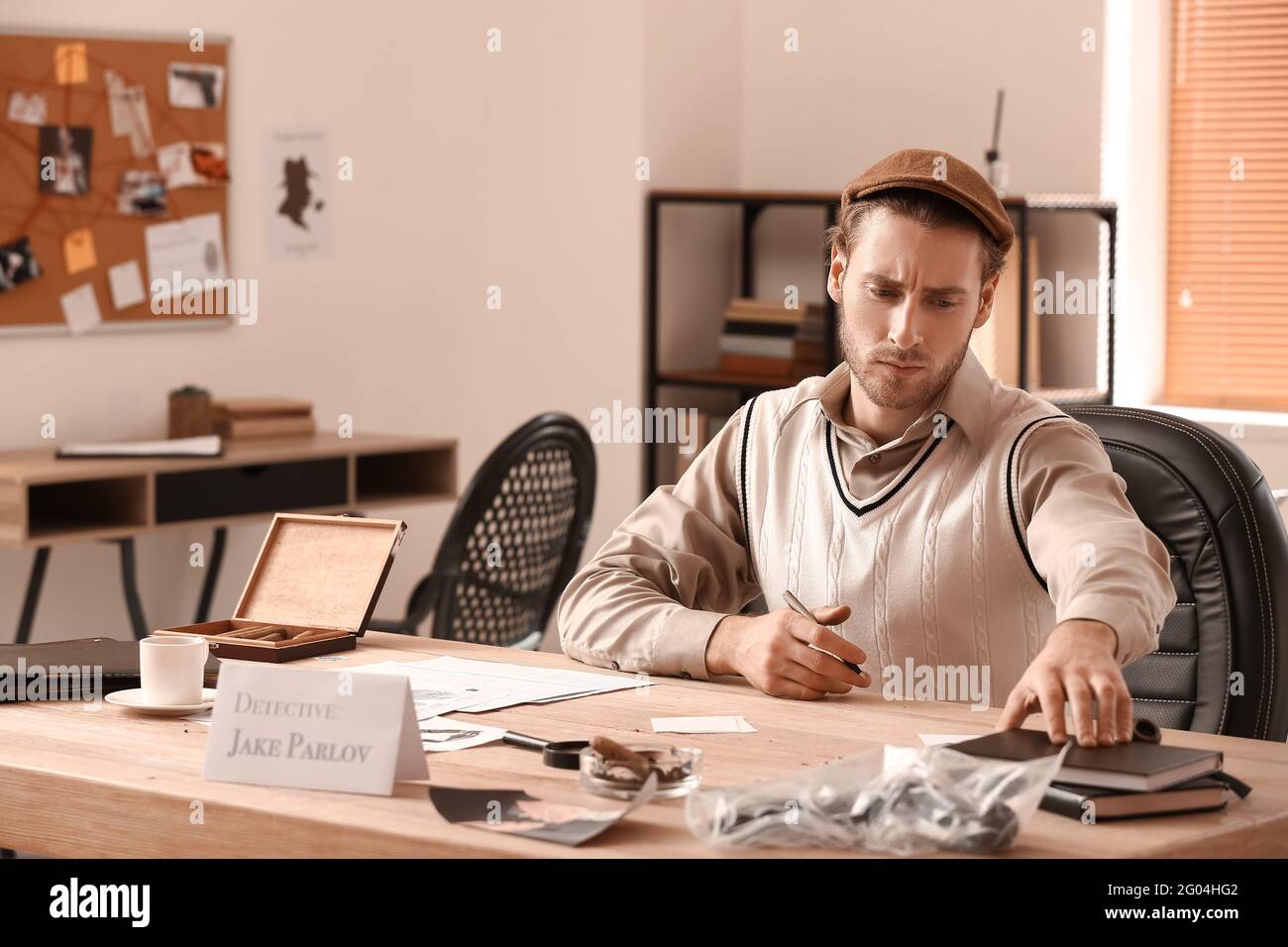 Detective processing evidence in office Stock Photo - Alamy