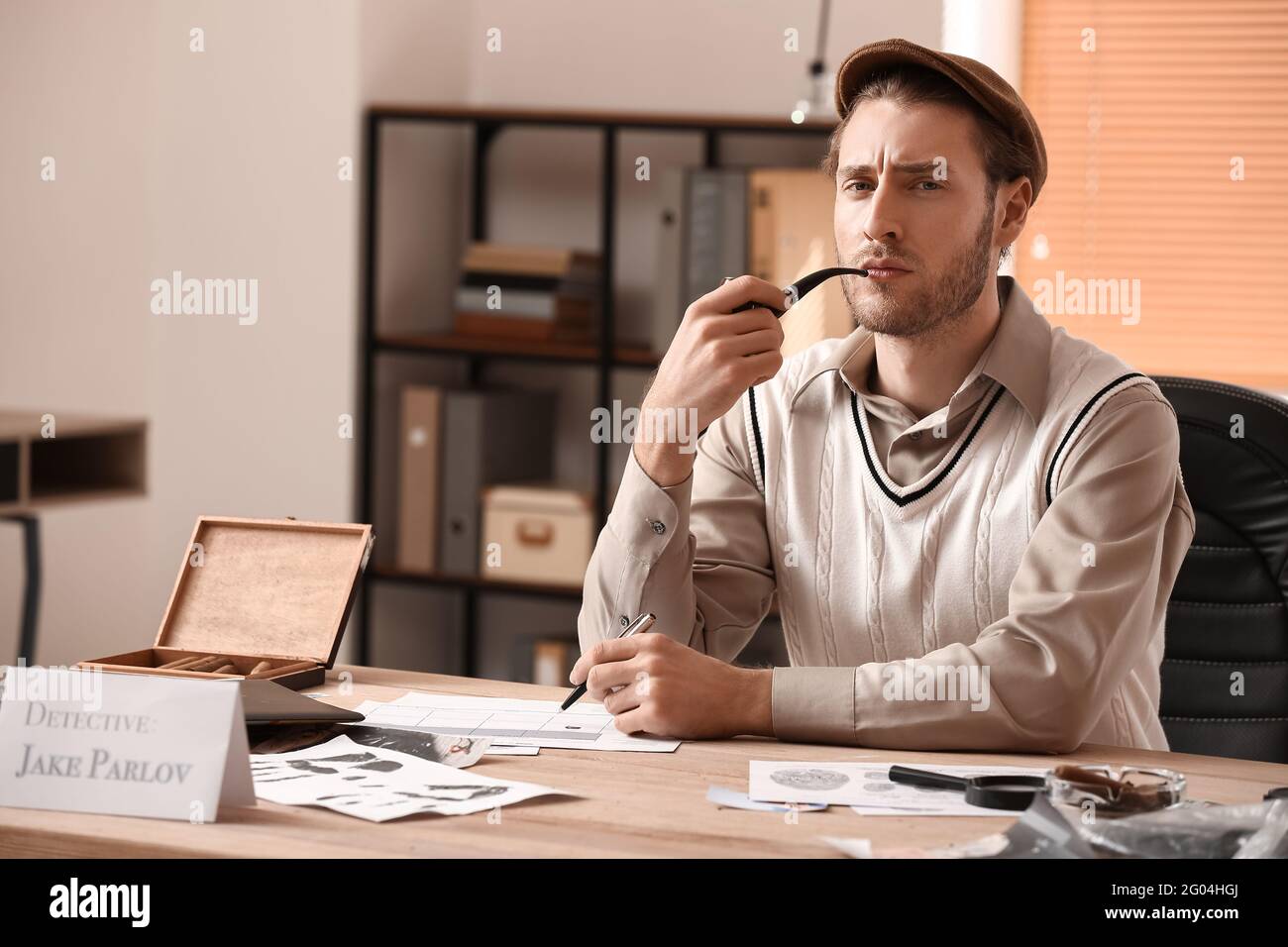 Detective processing evidence in office Stock Photo - Alamy