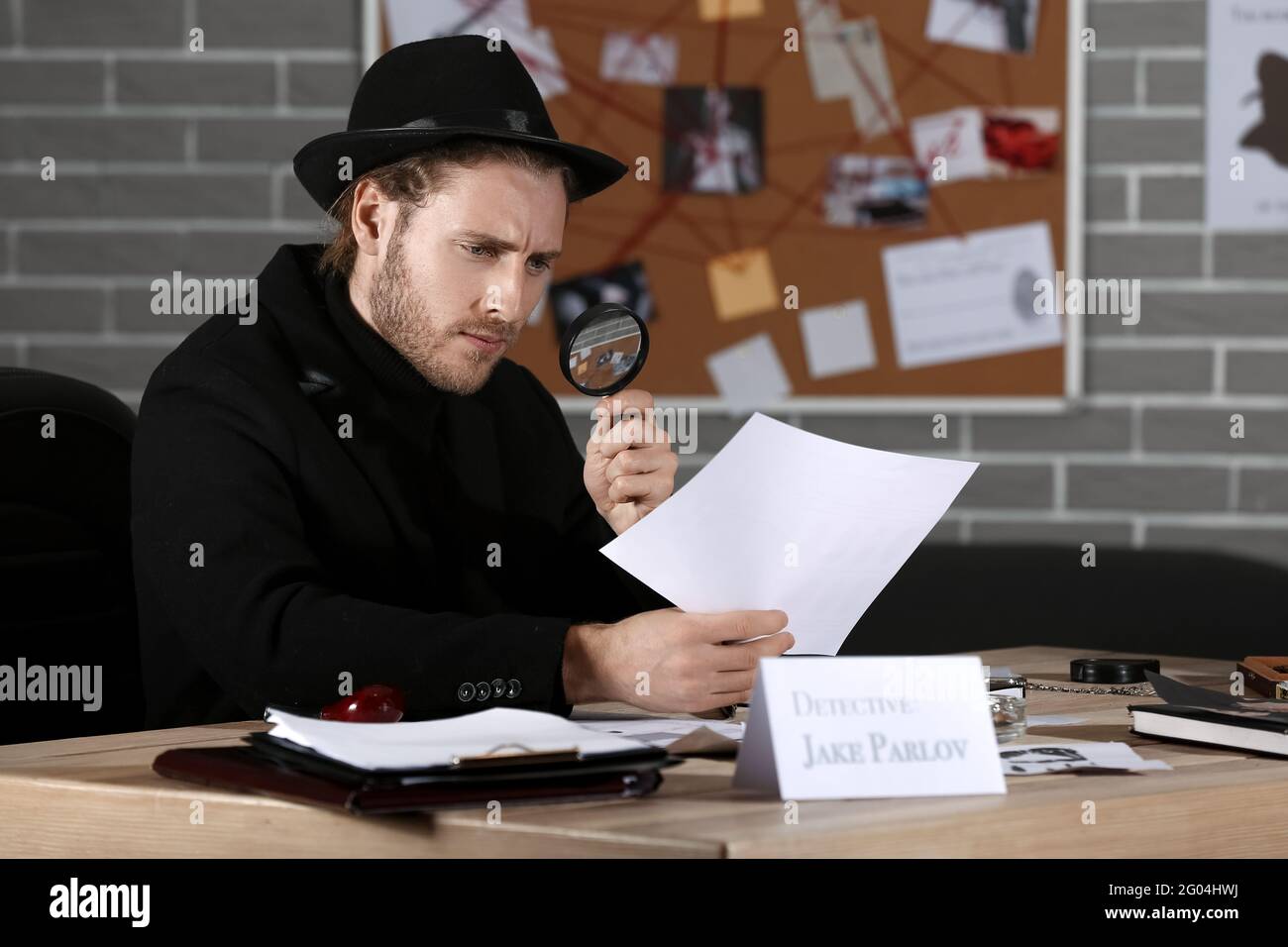 Detective processing evidence in office Stock Photo - Alamy