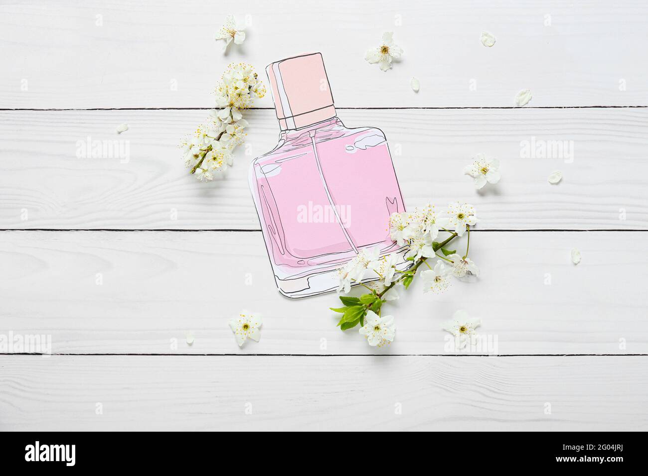 Beautiful blooming branches and drawn perfume on light wooden ...