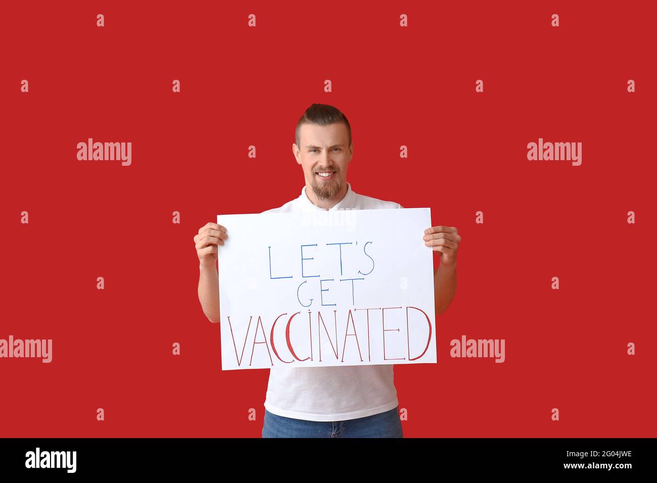 Young man holding poster with text LET'S GET VACCINATED on color ...