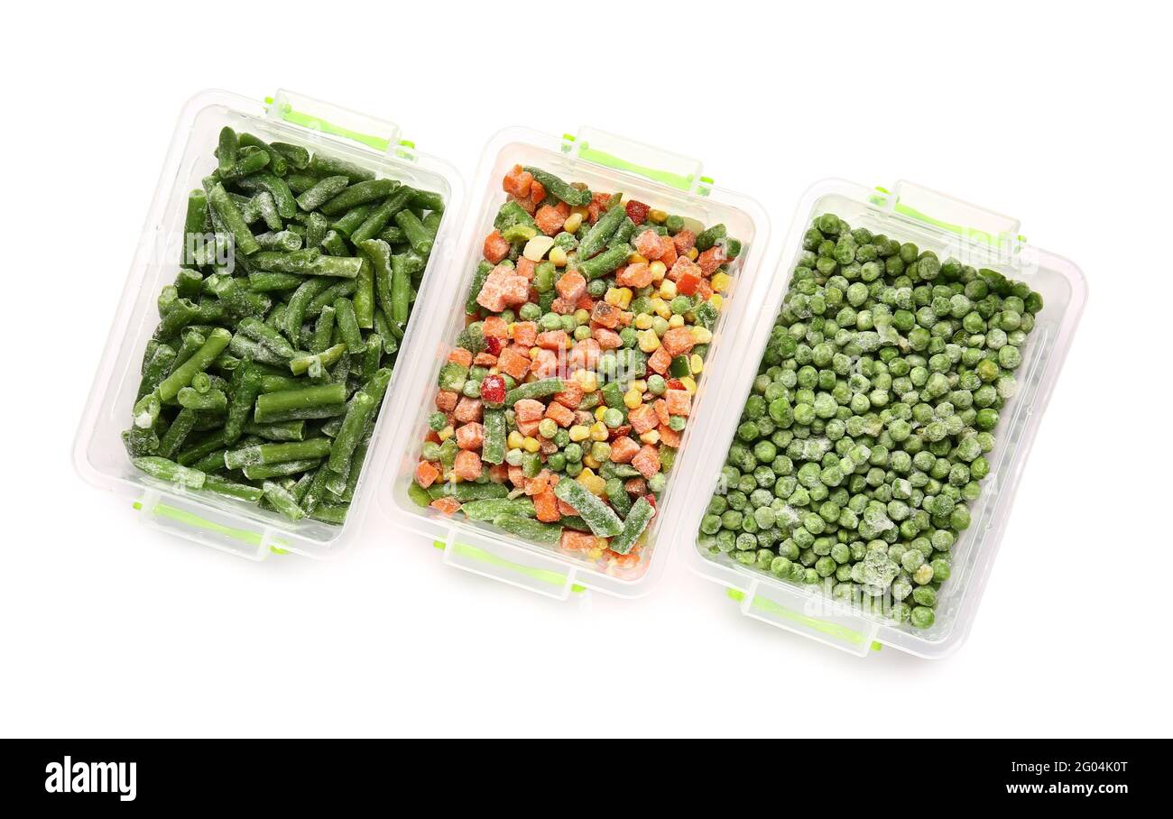 Plastic containers with frozen vegetables on white background Stock ...