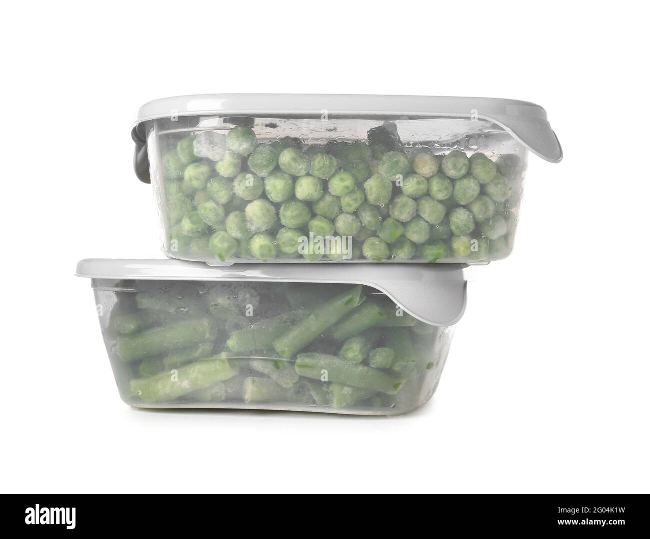 Plastic containers with frozen green peas and beans on white background ...