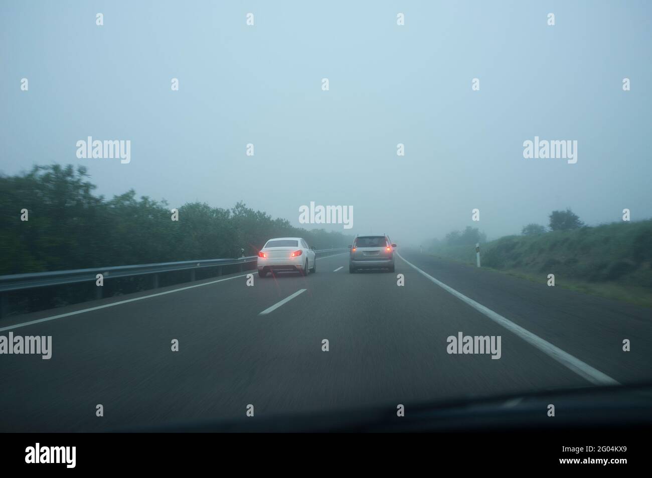 Car overtaking with heavy fog. Bad-weather driving concept Stock Photo ...