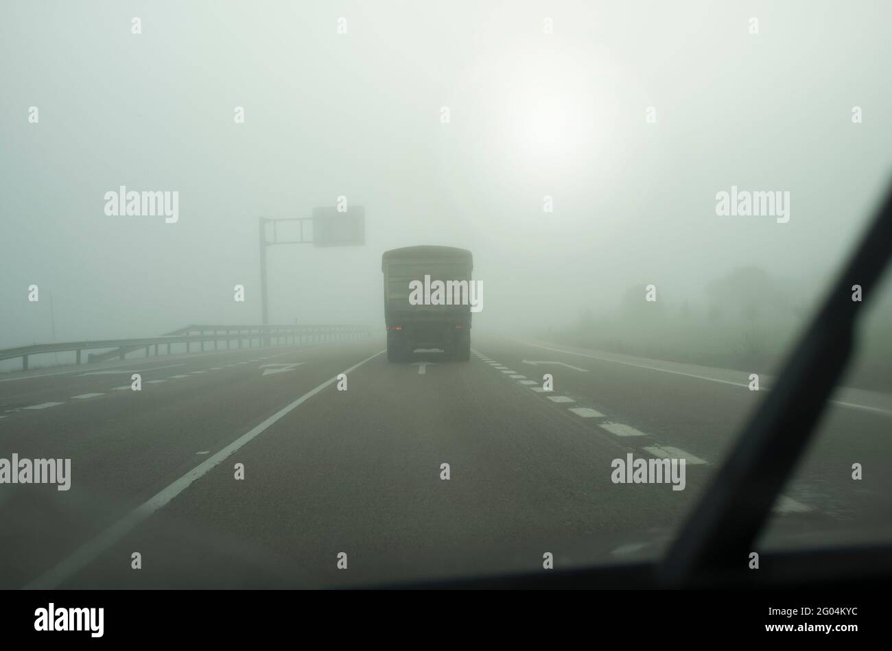 Driving behind a truck under dense fog. Bad-weather driving concept ...
