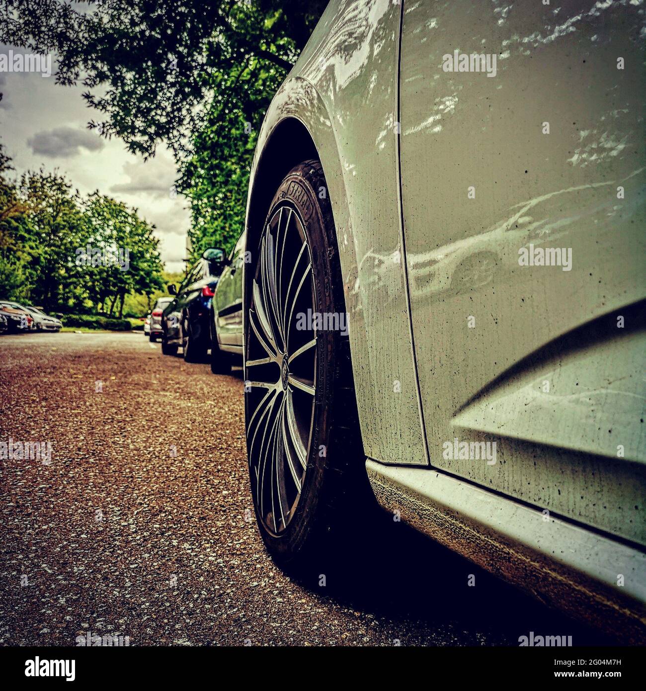 Closeup shot of a dirty white car parked on a street Stock Photo - Alamy