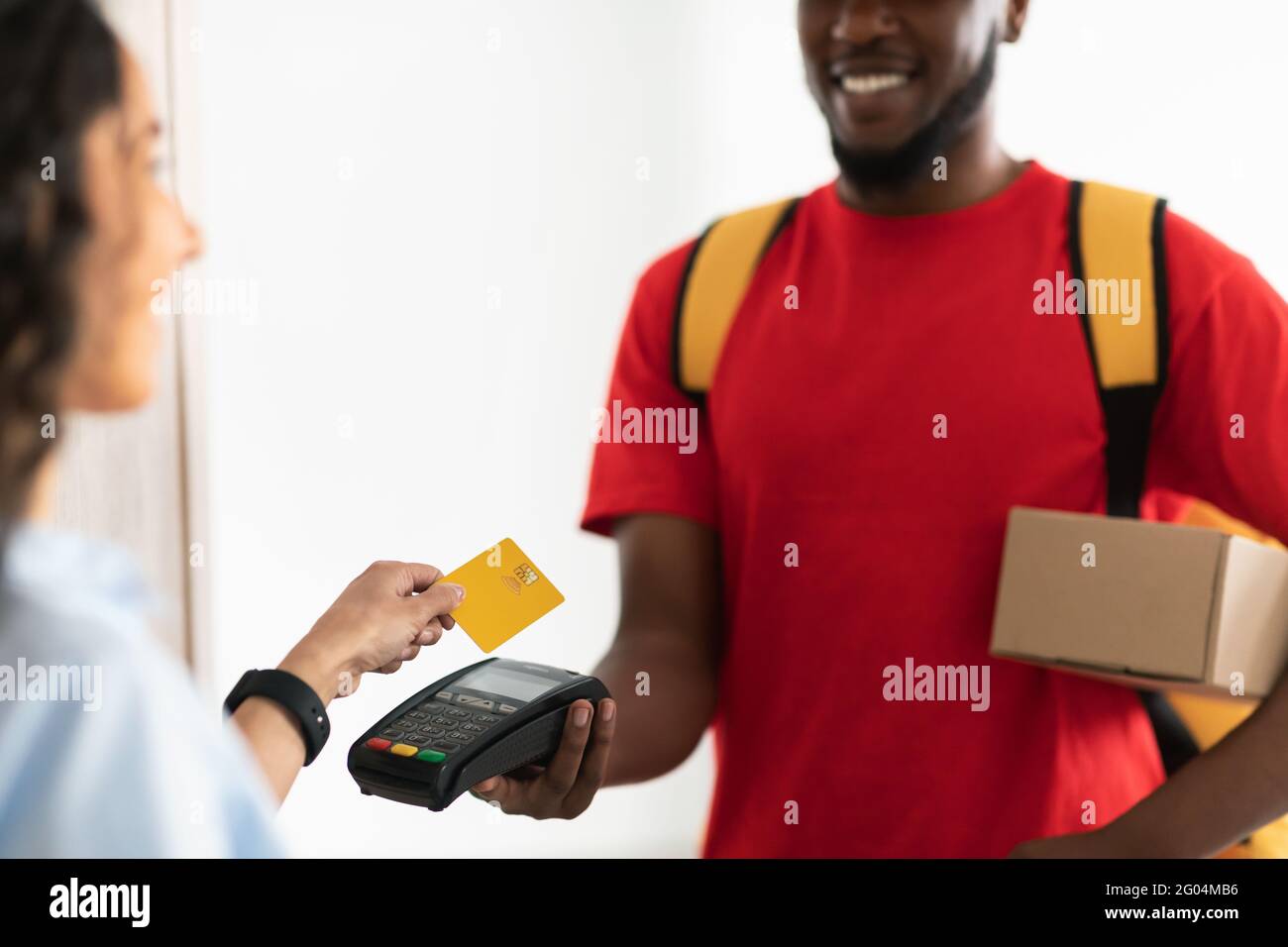 Portrait of black man holding POS machine for payment Stock Photo - Alamy