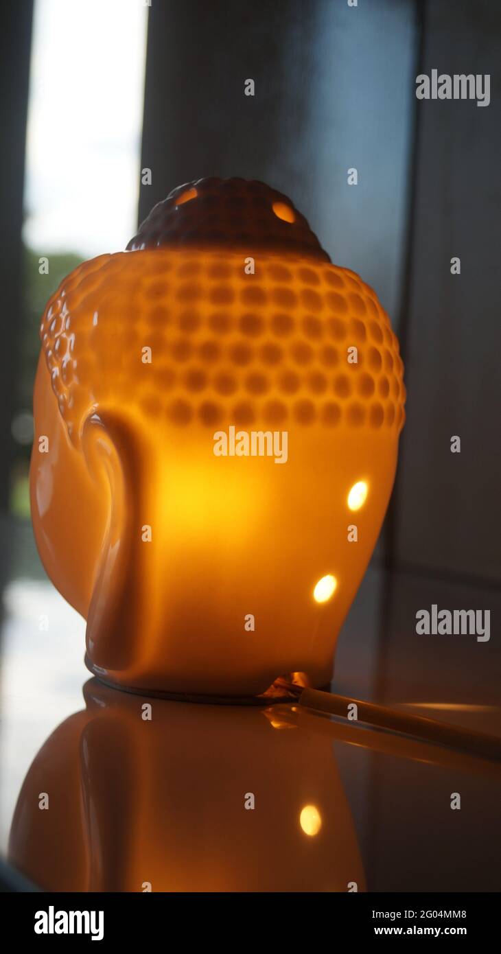 Illuminated Buddha statue lamp Stock Photo - Alamy
