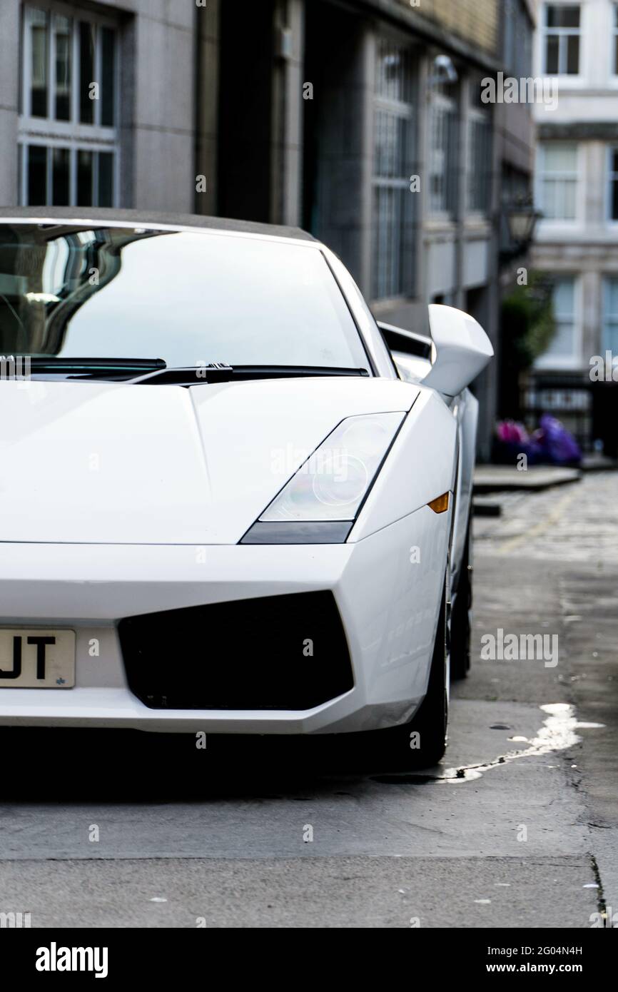 Modern white car parked on a street Stock Photo - Alamy