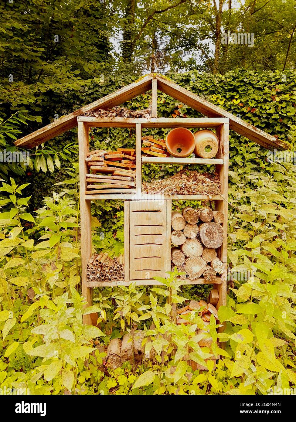 Vertical shot of a house-shaped structure for holding wooden objects in ...