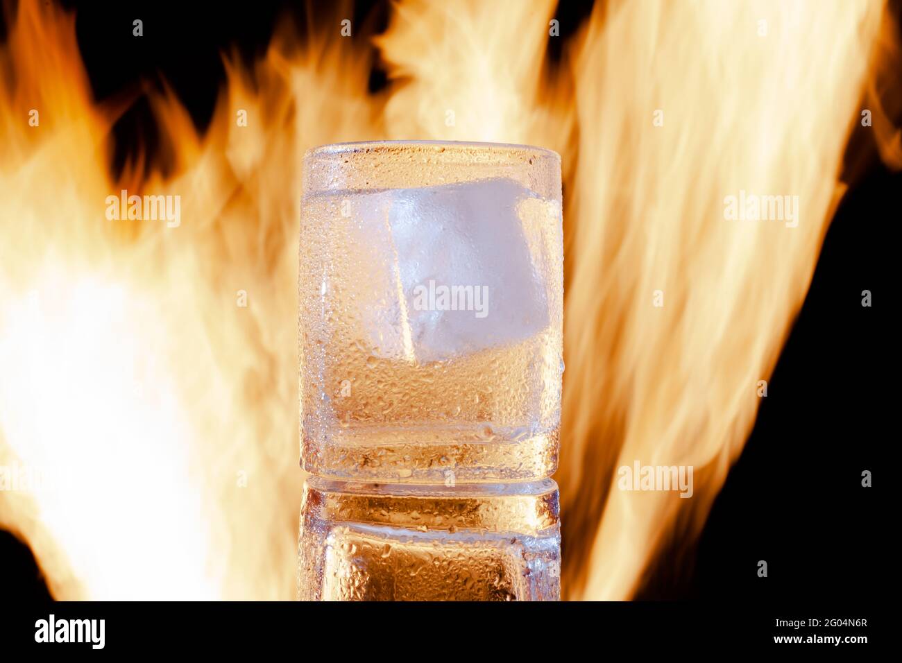 glass of vodka with ice on fire on a black background Stock Photo - Alamy
