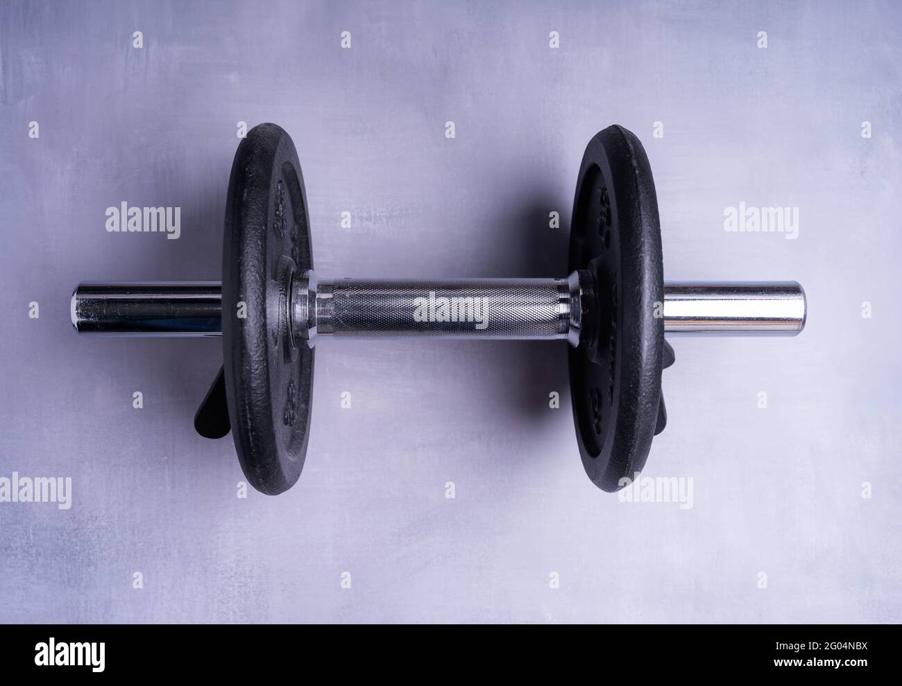Top view of collapsible dumbbells on a gray background Stock Photo - Alamy