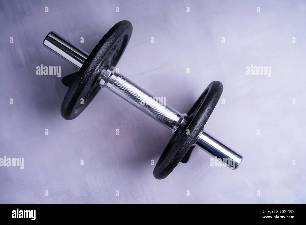 Top view of collapsible dumbbells on a gray background Stock Photo - Alamy