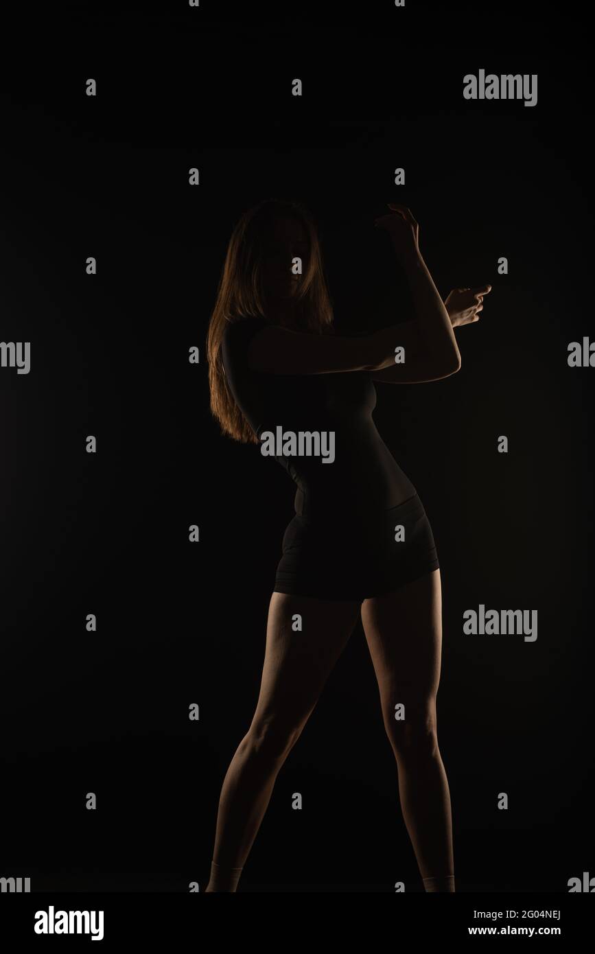 Female silhouette is having a perfect asymmetrical posture Stock Photo ...