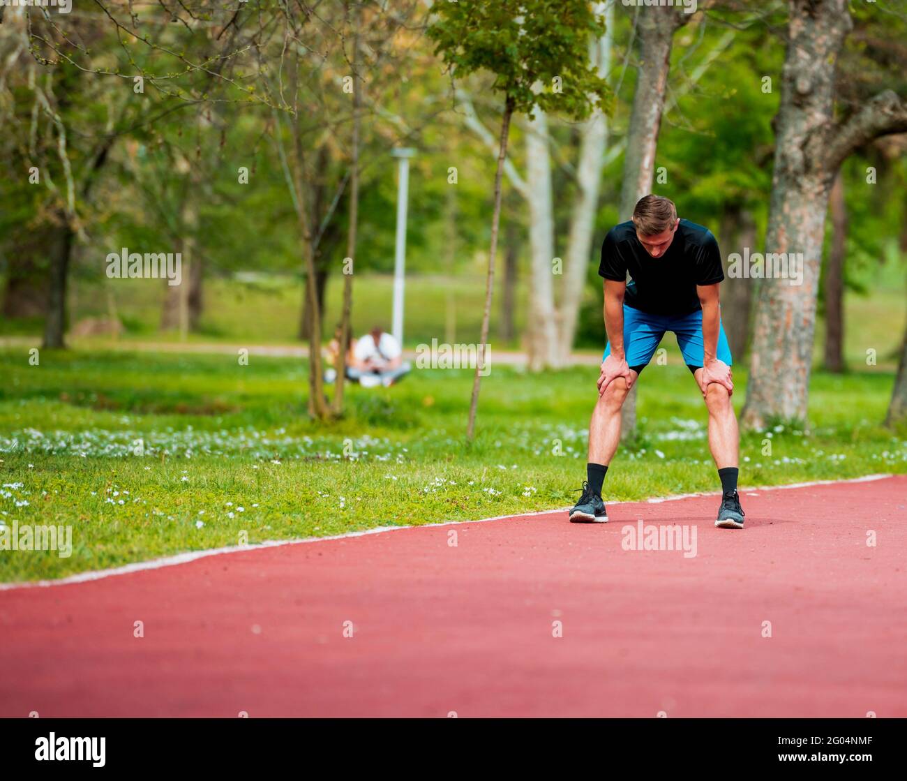 Tired young man runner taking a rest after running.workout concept ...