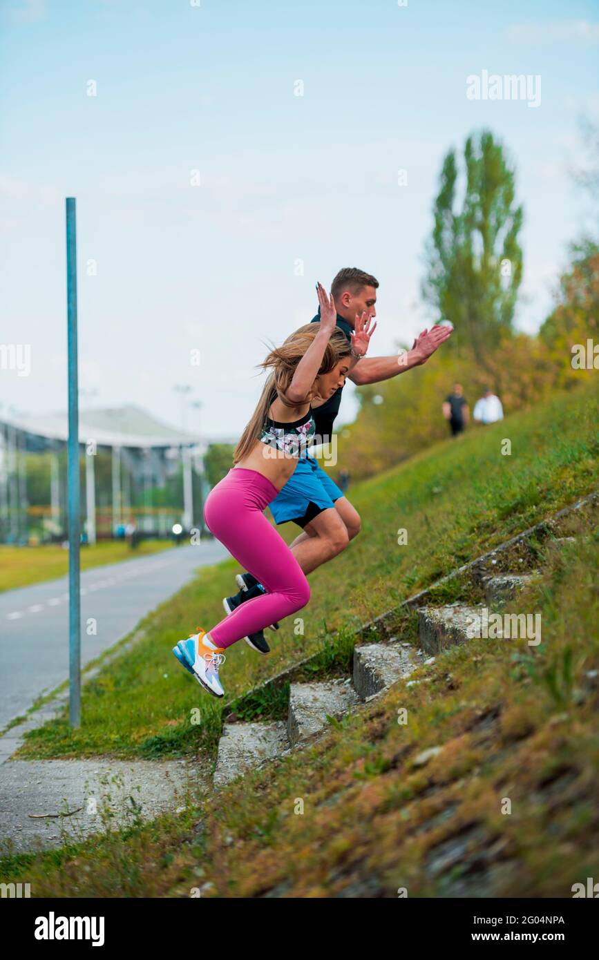 Portrait of a young happy couple racing each other and having some fun ...