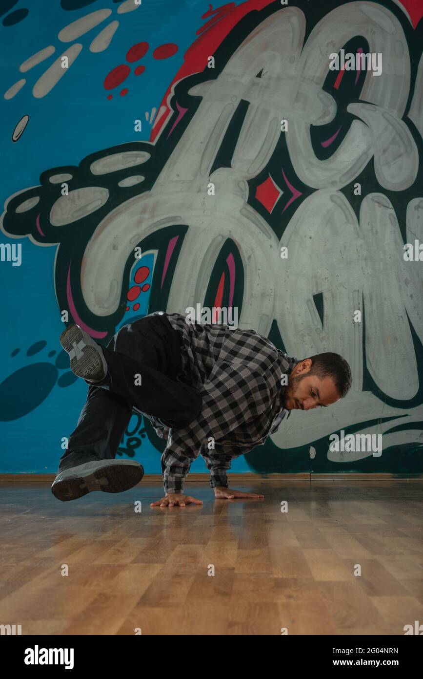Trendy young man dancer dancing in front of graffiti Stock Photo - Alamy