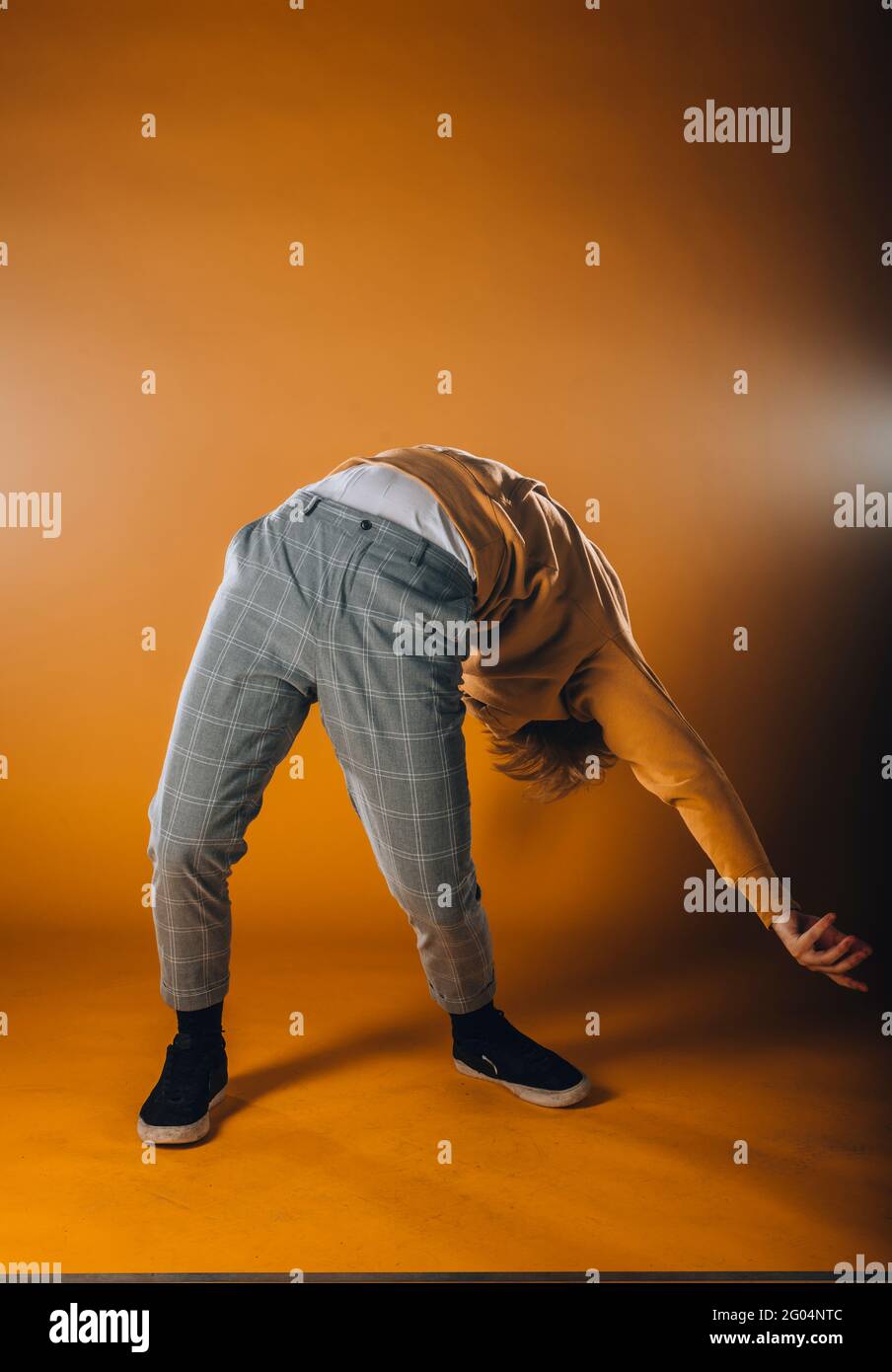 Flexible athletic man during an intense dance exercise while jumping ...