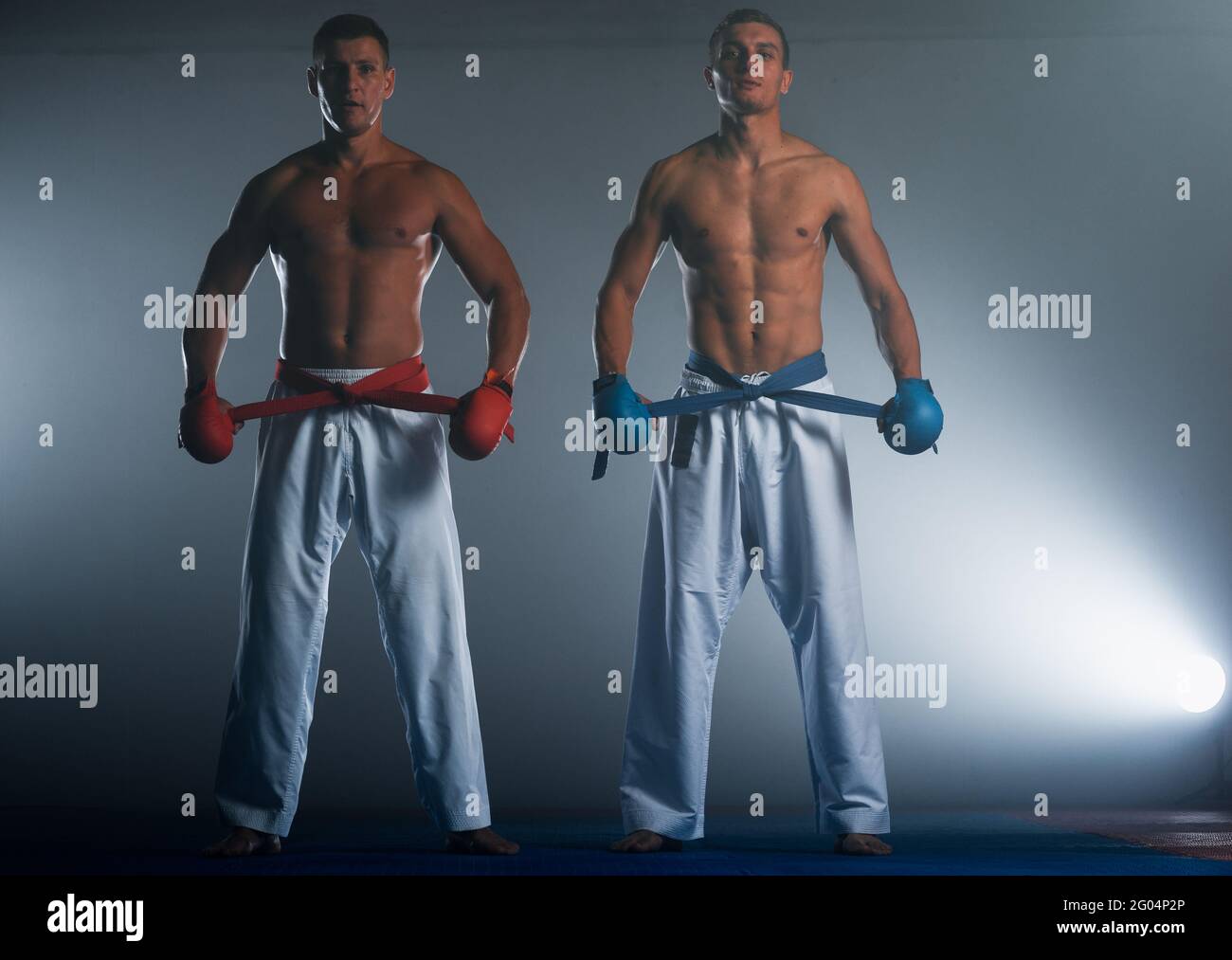 Strong fit athlete, karate men or fighters in white kimono, suit, with ...