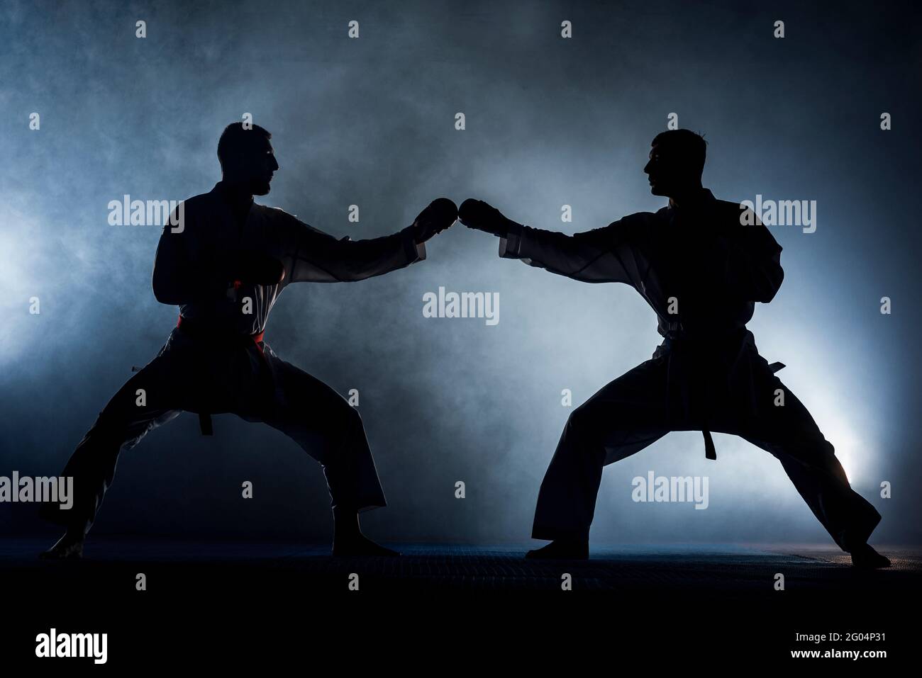 Karate men with black belt posing, champion of the world on black ...