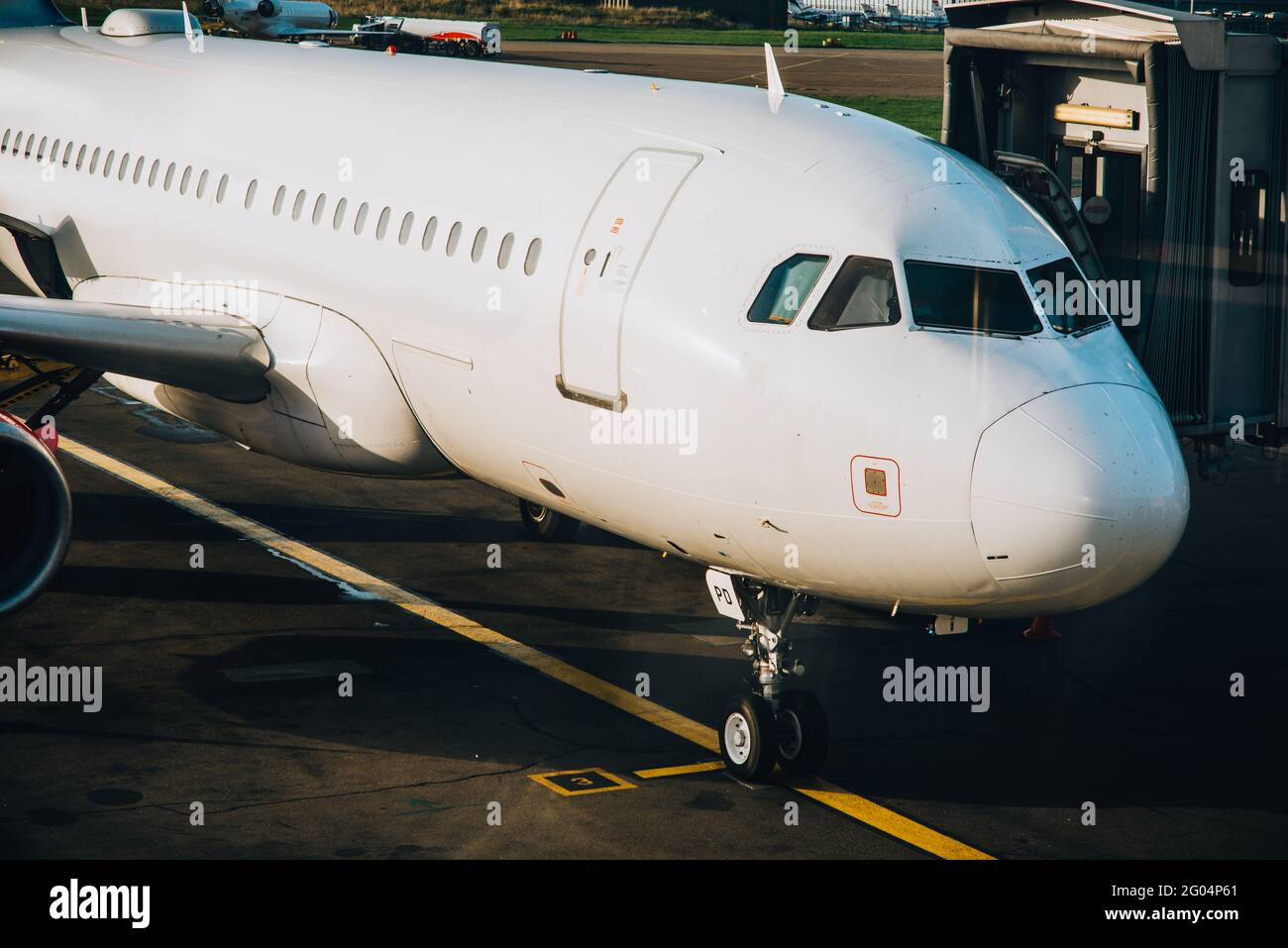 Airplane with jet engines connected to an airgate at the airport Stock ...