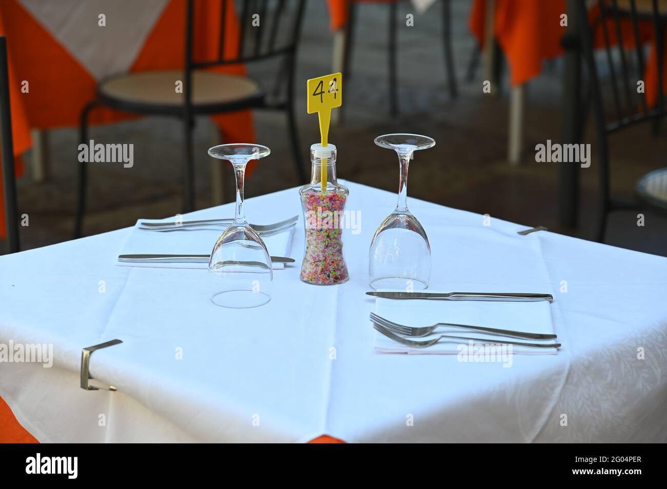 Restaurant terrace table arranged for dinner; table setting under "new ...