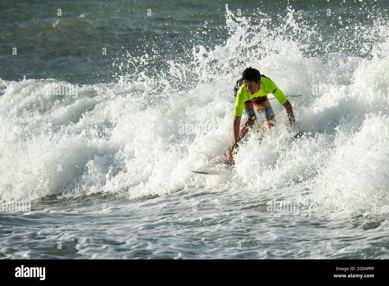 Maui, Hawaii. Young male surfer riding the waves in the pacific ocean ...