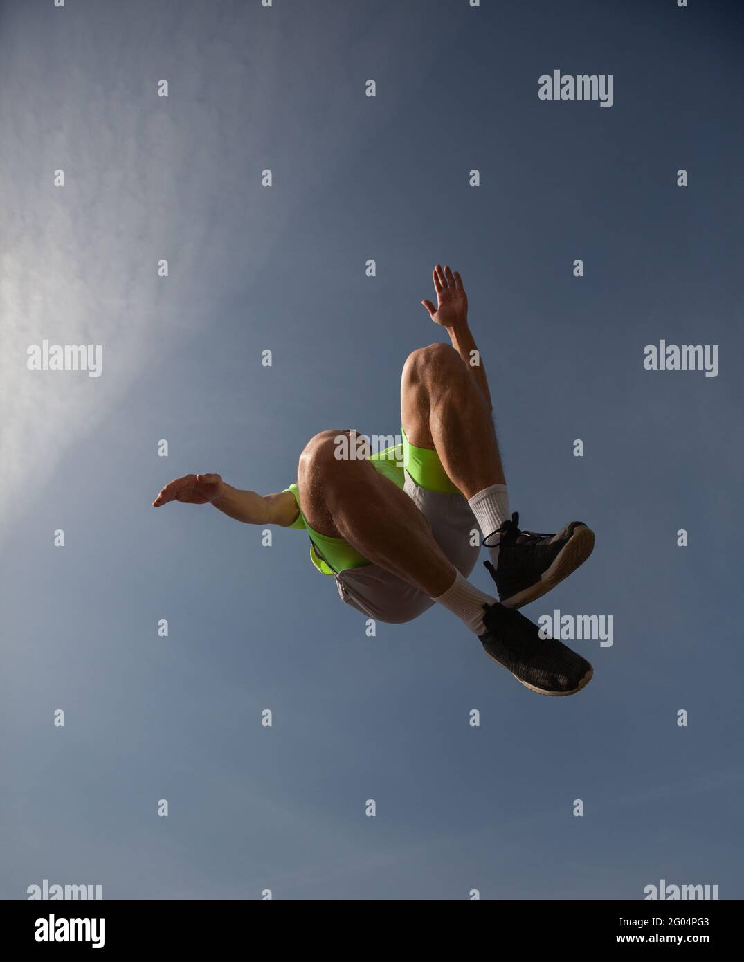 Handsome and attractive guy is jumping above the camera, low angel ...