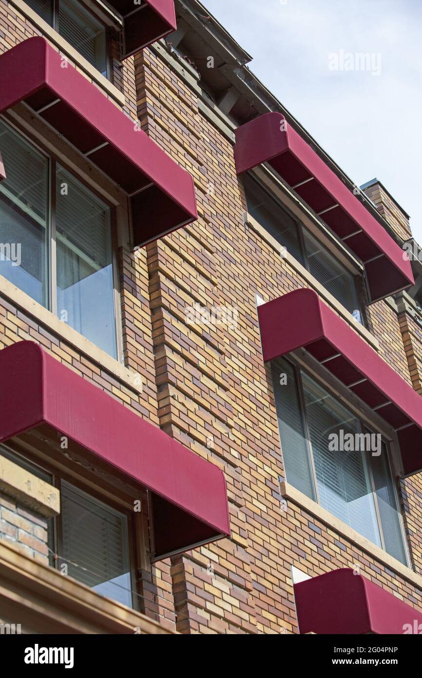 Side-view shot of the building with similar windows and brown bricks ...