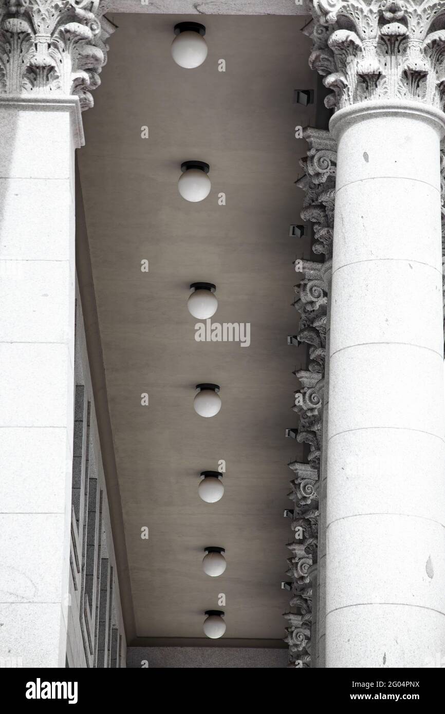 Vertical shot of the outside round lamps and two columns that surround ...